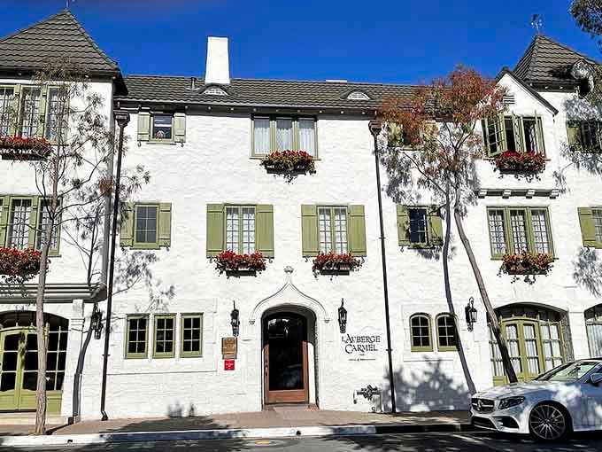 Flower boxes and green shutters dress up these European-inspired facades better than any Hollywood set designer could.