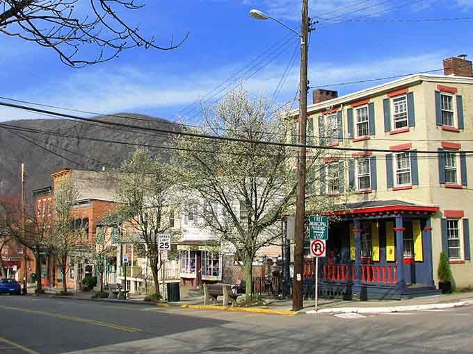 Spring sunshine bathes the street in golden light as colorful buildings stand ready to welcome wandering visitors.