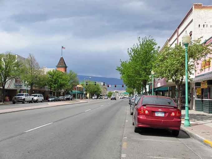 Mature trees shade the sidewalks here, creating natural air conditioning that beats any mall's climate control system.