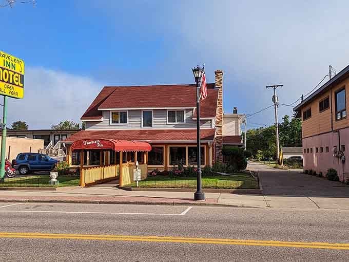 That red awning practically shouts "come on in" to hungry travelers seeking authentic small-town hospitality and comfort.