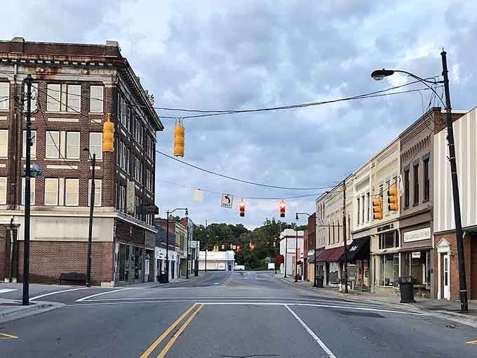 Classic brick storefronts line this peaceful street, their windows reflecting decades of community stories and memories.