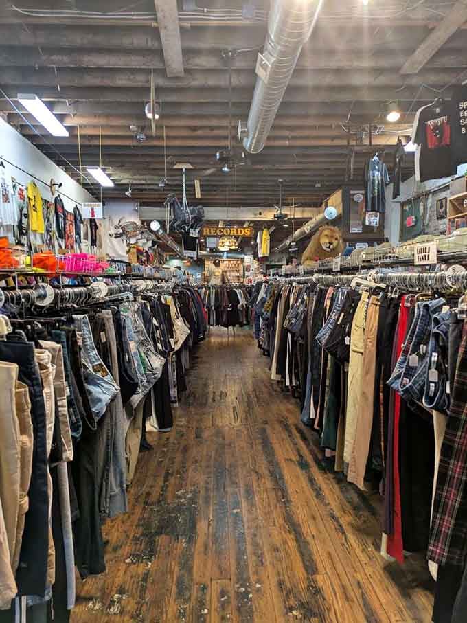 Inside, wooden floors creak with character as racks overflow with denim, vintage tees, and treasures from decades past.