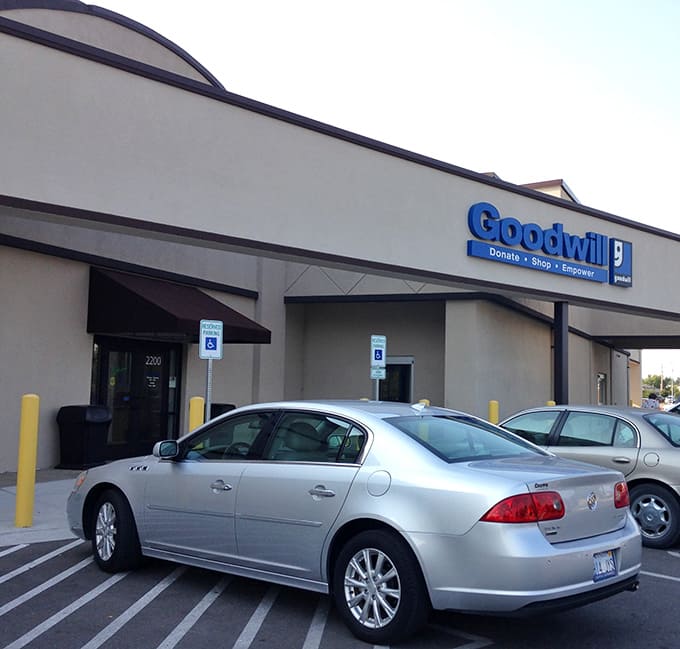 The blue Goodwill sign promises an organized treasure hunt where one person's castoffs become another's gold.