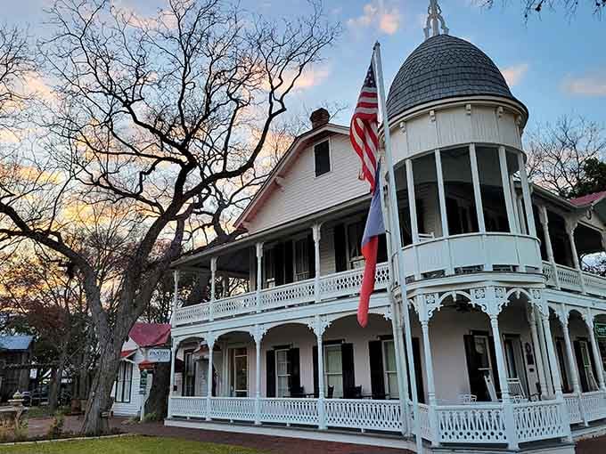 That turret and wraparound porch belong on a postcard celebrating Victorian elegance meeting Texas Hill Country hospitality perfectly.