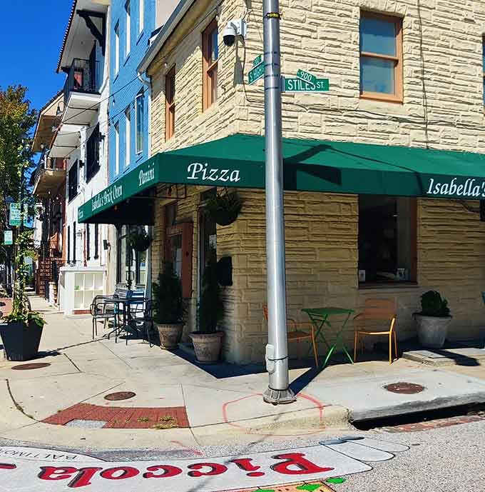 The charming stone building and green awnings of Isabella's create an inviting neighborhood vibe. Pizza with a side of Baltimore charm.