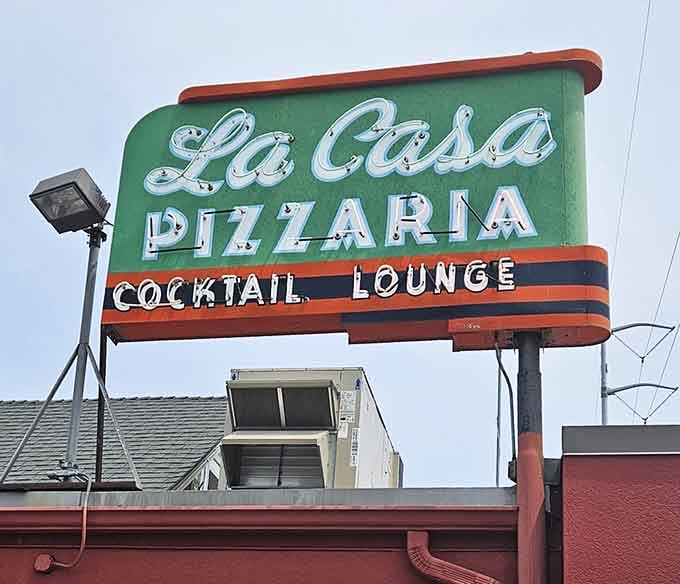 The red and green sign glows like a beacon for pizza lovers. Their rectangular crust has launched a thousand road trips.