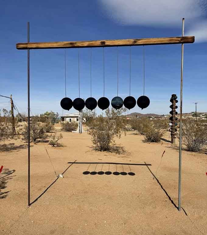 Giant hanging spheres create a desert symphony of shadows, turning simple materials into mesmerizing outdoor instruments.