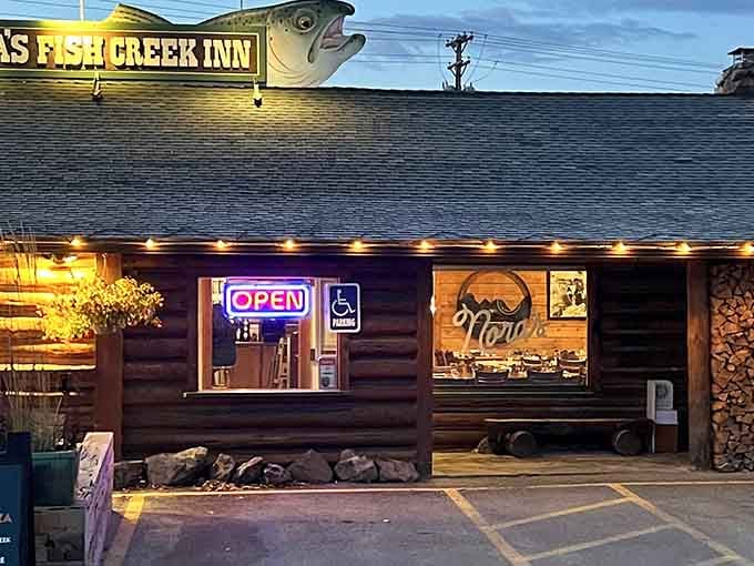 At night, Nora's wooden exterior glows like a beacon for hungry travelers. The fish on the sign isn't just decoration &ndash; it's a promise of what's inside.