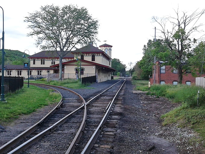 Railroad tracks curve through quiet spaces where industrial heritage meets small-town tranquility in unexpected harmony.
