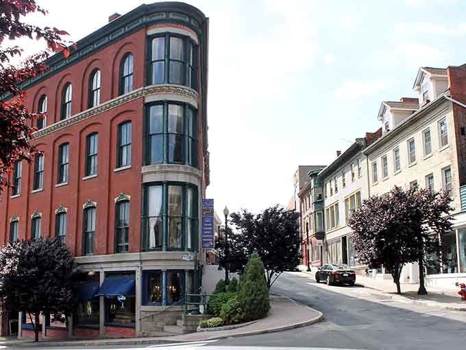 Curved bay windows catch the afternoon light on this charming corner, where old-world craftsmanship meets everyday neighborhood life.