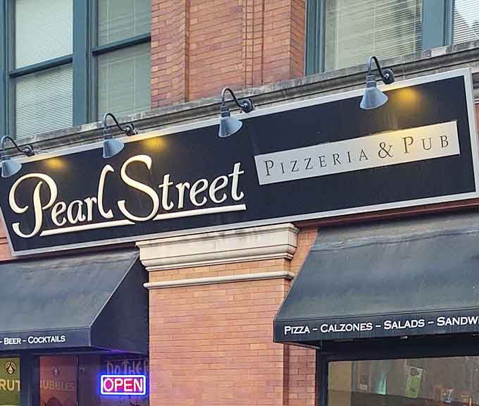 The elegant signage promises sophistication, but the pizza delivers pure, unadulterated comfort food bliss.