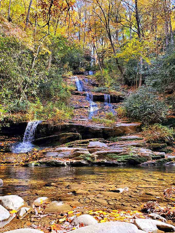 Fall foliage transforms this tiered waterfall into a painting worthy of any museum wall you've ever seen.