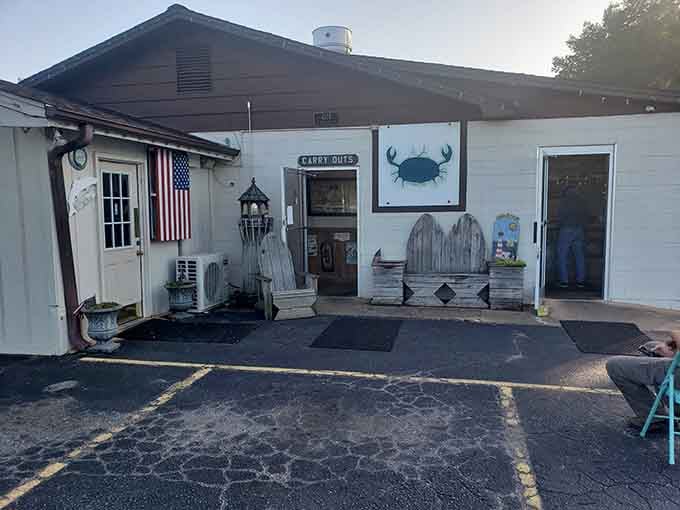 Coastal charm meets casual dining under this covered porch where American flags wave and seafood dreams come true.