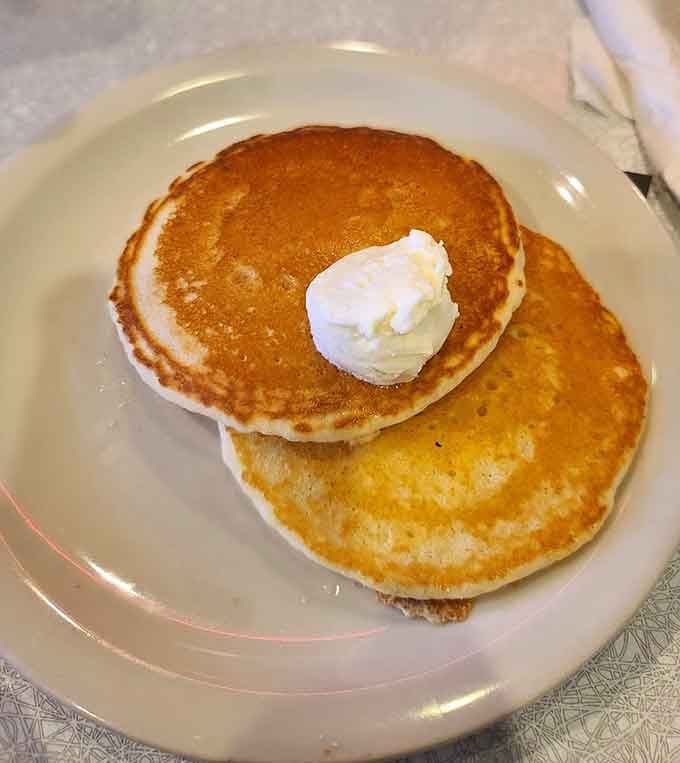 Golden pancakes topped with butter prove that sometimes simple perfection needs no improvement whatsoever.