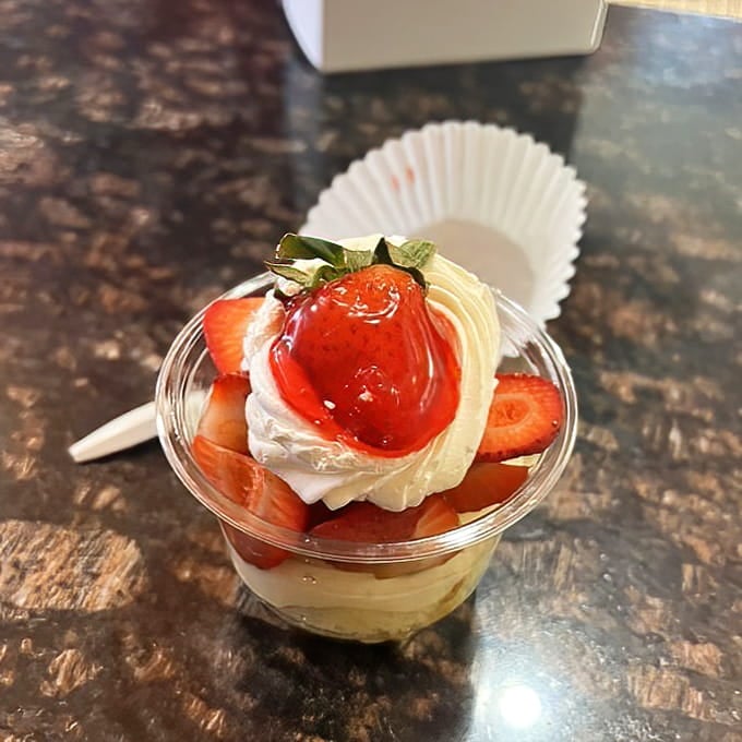 Fresh strawberries and cream in a cup, because sometimes happiness comes in portable form.