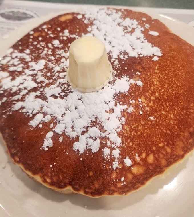 Golden pancakes dusted with powdered sugar and crowned with butter, because some mornings demand pure breakfast joy.