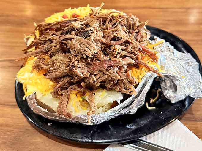 Behold the loaded potato in all its glory, piled high with tender pulled pork like edible architecture.