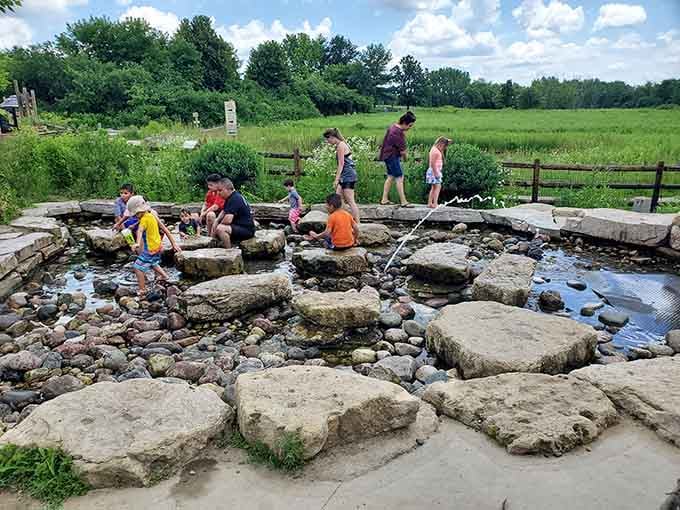 Kids engineering water flow systems while parents pretend they're not jealous of all that hands-on fun.