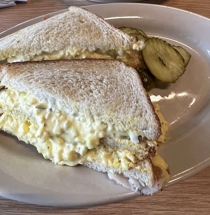 That egg salad is piled so high it's practically reaching for the ceiling with creamy ambition.