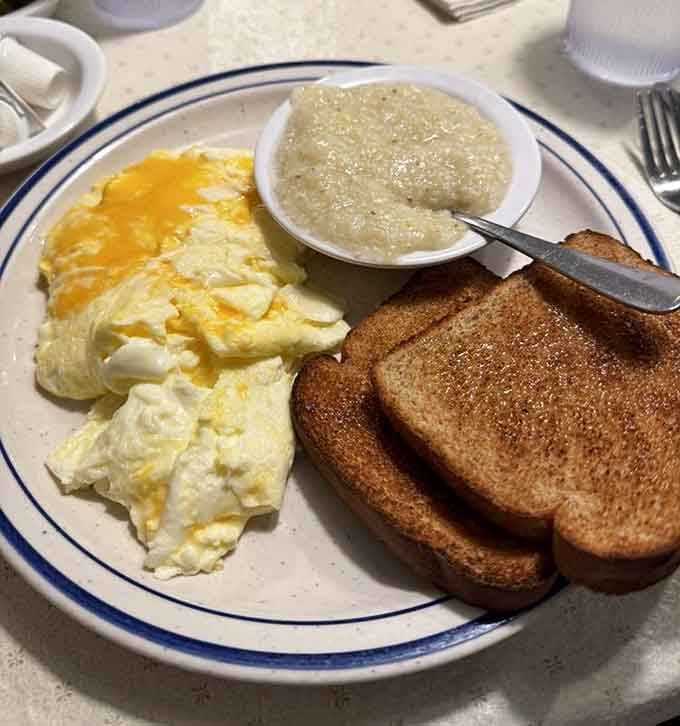 Perfectly cooked eggs and creamy grits with toast: the Southern breakfast trinity that never disappoints.