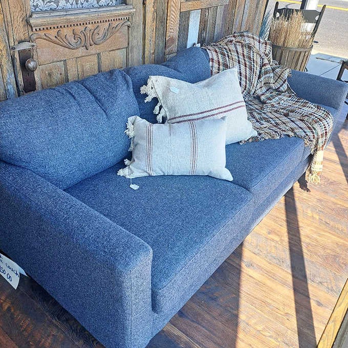 Cozy doesn't begin to describe it. This blue sofa with handcrafted pillows isn't just seating&mdash;it's an invitation to slow down.