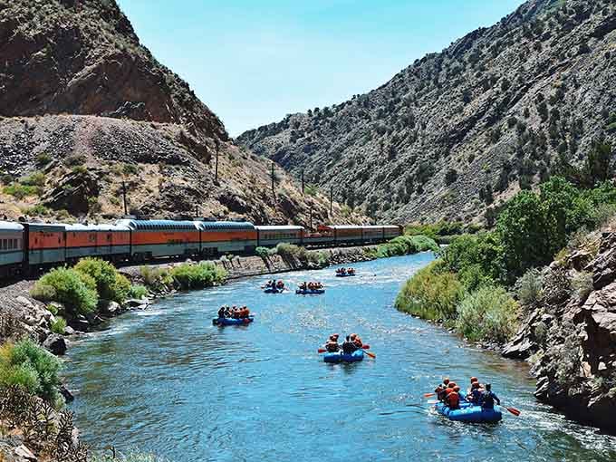 Rafters floating past the scenic train proves multitasking has never looked so gloriously Colorado.