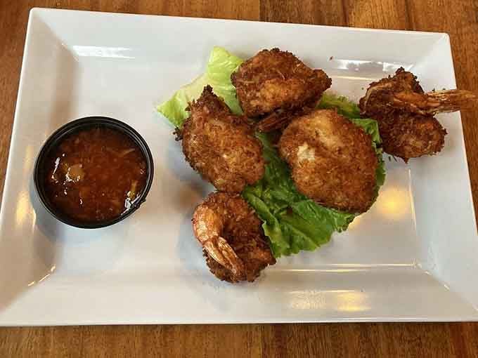 Golden coconut shrimp with a side of dipping sauce, because sometimes paradise comes on a white plate.