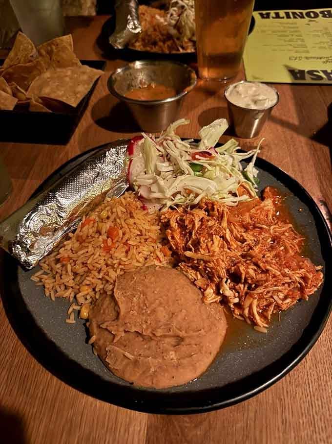The chicken tinga arrives with rice, beans, and a side of "how is there a waterfall in this restaurant?"