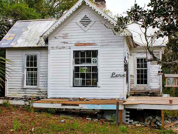 Weathered white siding and the word "Love" tell you everything about this charming cottage's gentle spirit.