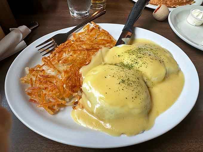Eggs Benedict draped in hollandaise with hash browns that could make a grown person weep with joy.