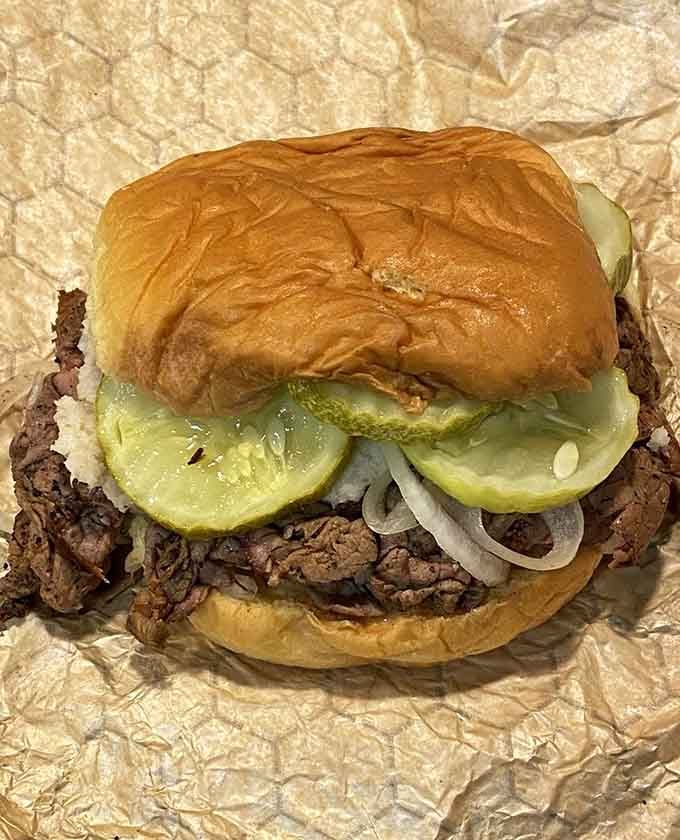 Behold the classic: thinly sliced pit beef piled high with pickles and onions on a Kaiser roll of glory.