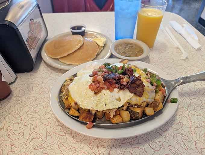 This breakfast skillet towers like Everest, proving that sometimes more really is more when it comes to morning fuel.
