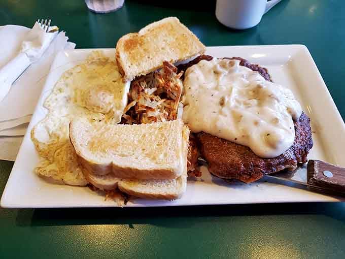 Behold the star of the show: chicken fried steak with a golden crust that audibly sings when your fork breaks through, all swimming in peppery gravy perfection.