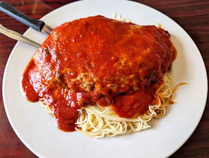 This chicken parmesan isn't messing around&mdash;a mountain of marinara-drenched goodness atop perfectly twirled spaghetti. Nonna would approve.