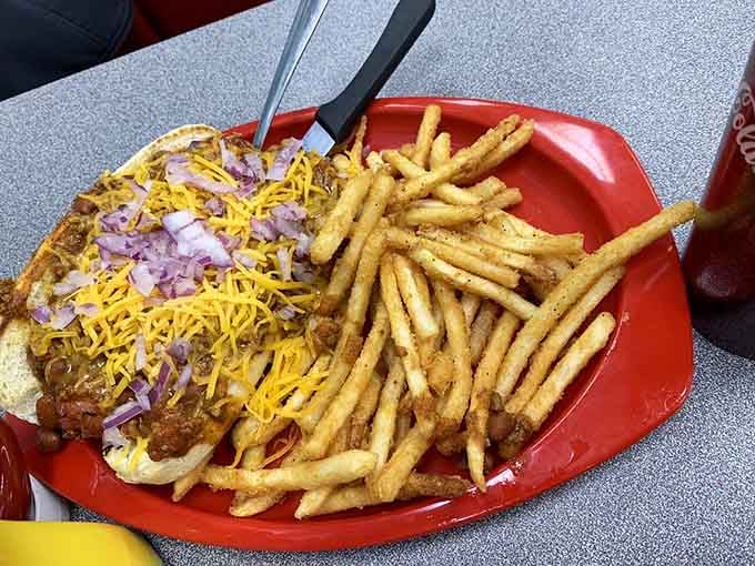 That's not just a chili dog—it's an edible love letter to Americana, complete with a golden mountain of fries that whisper, "Diet tomorrow."