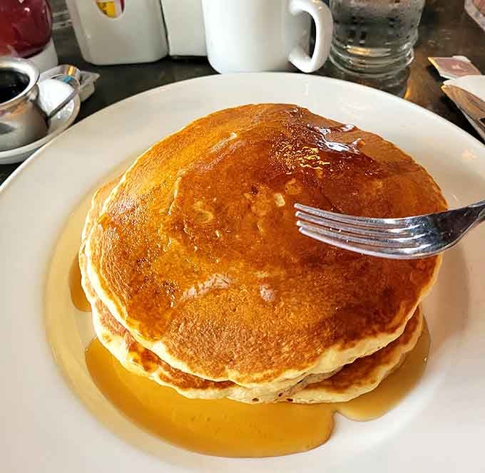 Golden, fluffy, and swimming in syrup, these pancakes could make the Mad Hatter himself weep with joy.