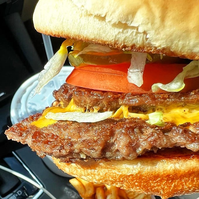 Two patties, melted cheese, and enough toppings to make your cardiologist nervous but your soul happy.