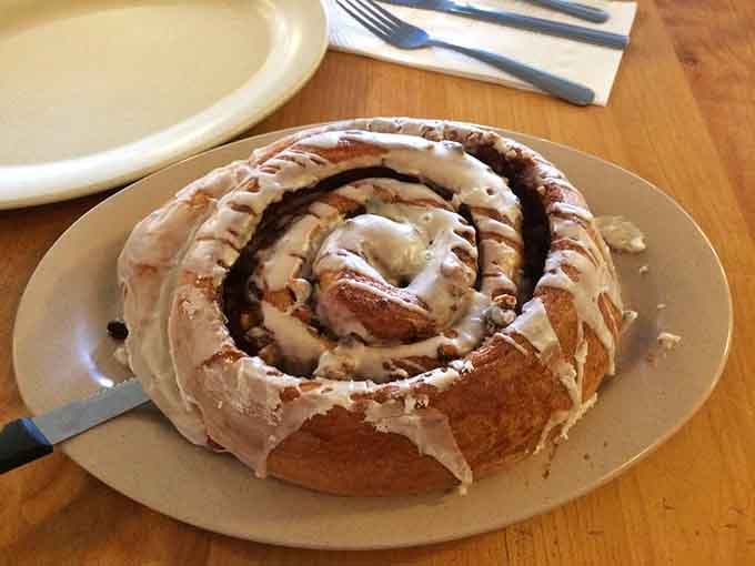 This cinnamon roll could double as a throw pillow, spiraled with sweet perfection and drizzled with icing glory.