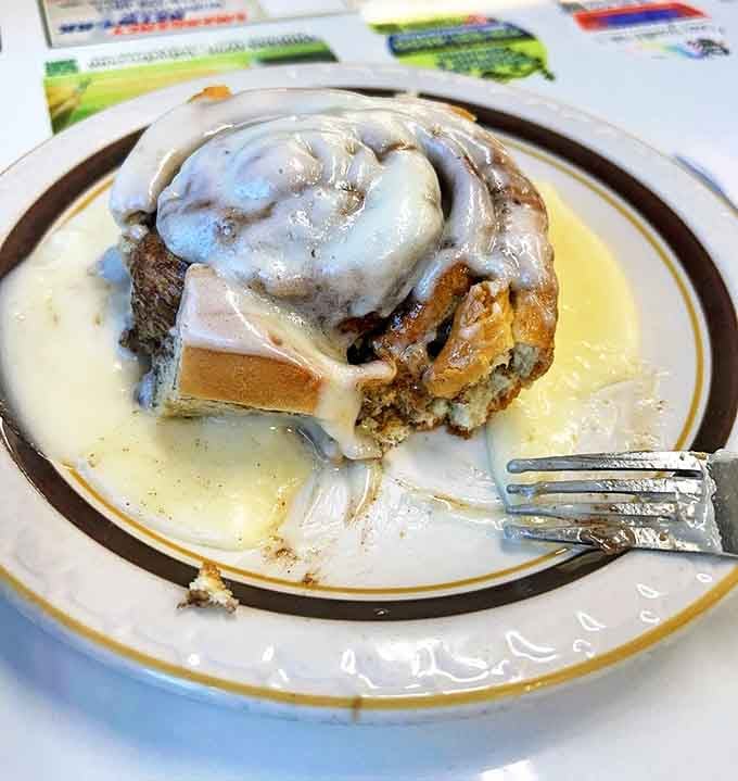 Behold the star attraction: a cinnamon roll so magnificent it makes all other pastries seem like mere rehearsals for this grand performance.