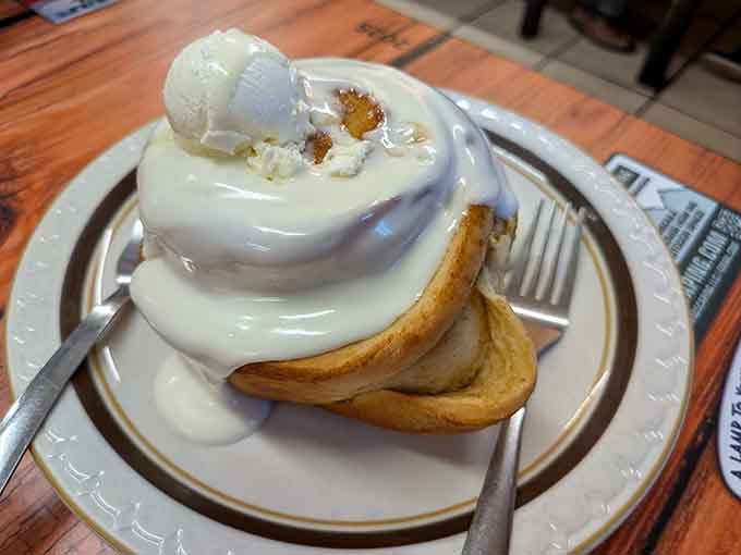This cinnamon roll isn't just breakfast&mdash;it's an event. Cream cheese frosting cascades over warm dough like a sweet alpine avalanche.