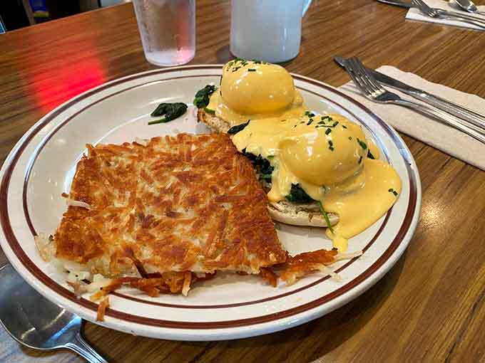 Eggs Benedict with hash browns so golden they could star in their own commercial.