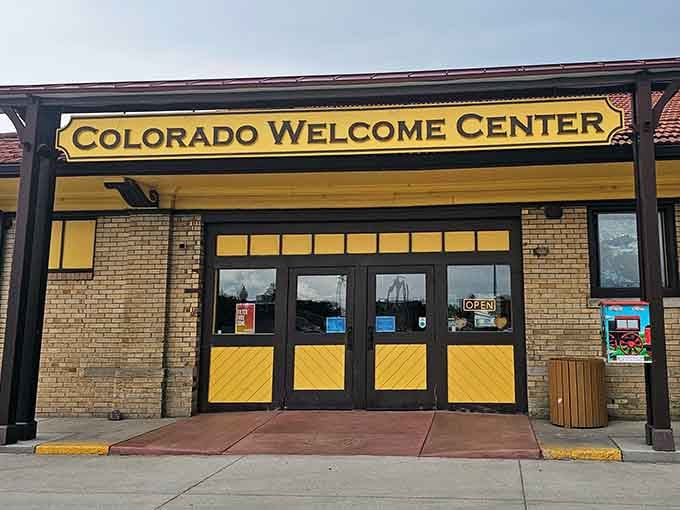 The Colorado Welcome Center greets visitors with that cheerful yellow signage that practically screams "affordable living ahead!"