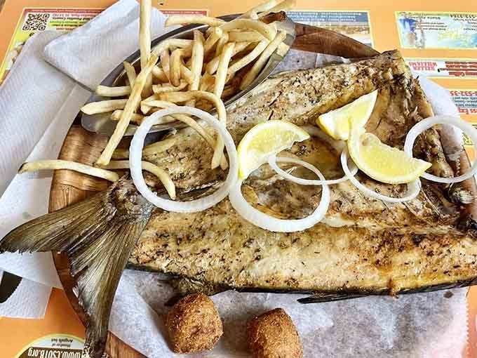 Smoked mullet arrives looking like it just won the lottery, golden and gorgeous with fries for backup.