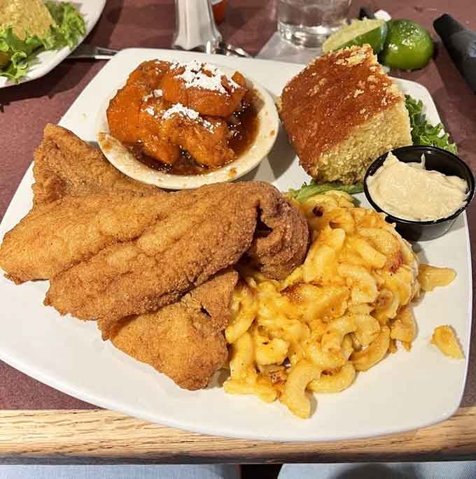 Golden catfish that crispy deserves its own standing ovation, accompanied by mac and cheese and that glorious cornbread.