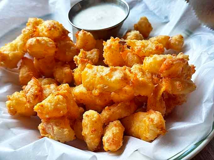 Golden-fried perfection! These cheese curds aren't just appetizers&mdash;they're little nuggets of happiness that squeak with Wisconsin pride.