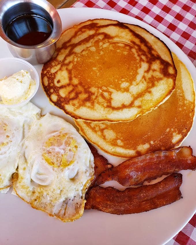 Those golden pancakes could double as frisbees, and honestly, that's exactly the portion size we're looking for here.