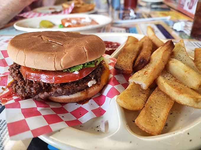 A perfectly seasoned burger with crisp lettuce and fresh tomato, served alongside golden fries that know their purpose in life.