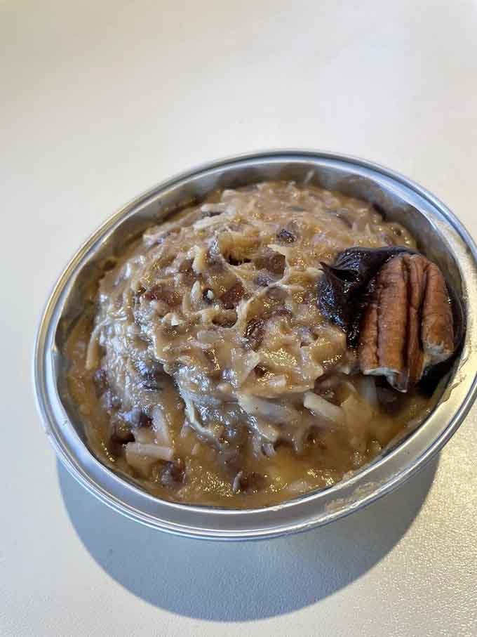 German chocolate cake topped with pecans that looks like comfort food decided to get fancy for a special occasion.