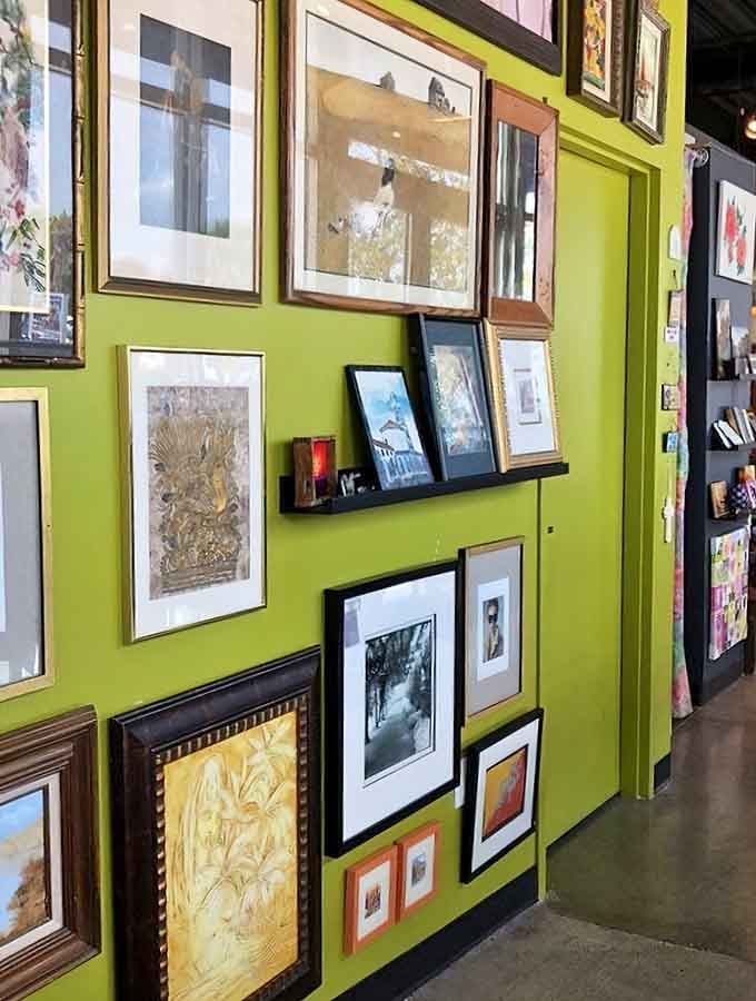 That lime green wall pops like a 1960s mod party, showcasing framed art in every style imaginable.