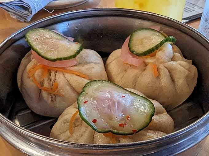 Delicate steamed buns that look like little edible clouds, each one hiding its own delicious secret inside.
